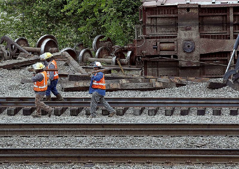 Train cars holding lumber go off rails