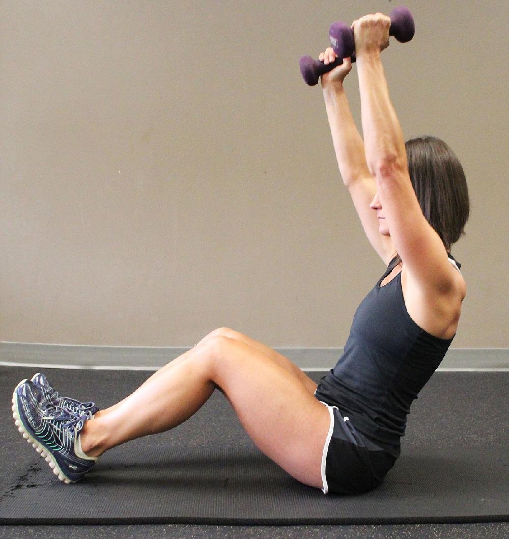 Seated dumbbell lift challenges spinal alignment