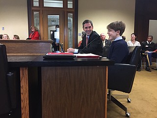 Mason Cyprus Oury, accompanied by Rep. Greg Leding, D-Fayetteville, testifies why the Arkansaurus fridayi should be recognized as the state dinosaur Wednesday, Jan. 18, 2017.