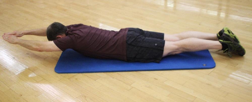 Floor Angel warms up lower back for core routine