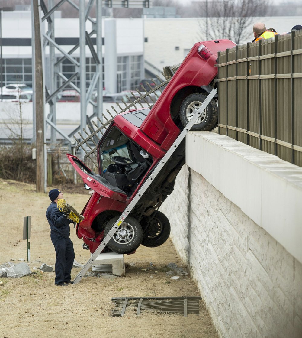PHOTOS: Pickup skids off icy overpass in Northwest Arkansas, ends up ...