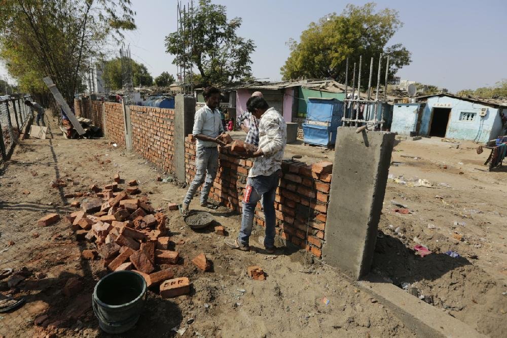 Wall rising at India slum ahead of visit by Trump