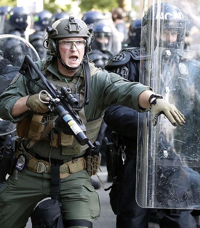 Critics say tensions escalated by police wearing riot gear | The ...