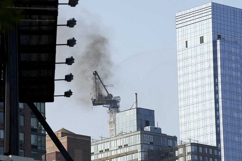 Pedestrians scatter as fire causes New York construction crane's arm to ...