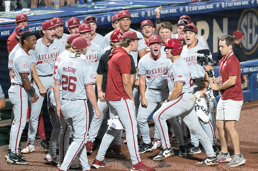 Arkansas players greet catcher Ryder Helfrick (right, batting helmet ...