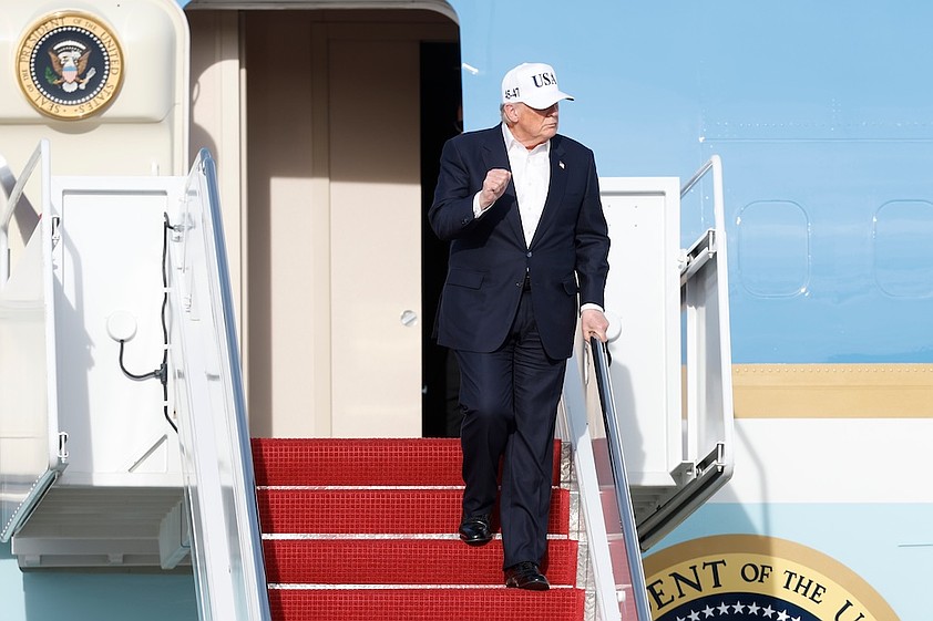 President Donald Trump walks down the stairs of Air Force One upon his ...