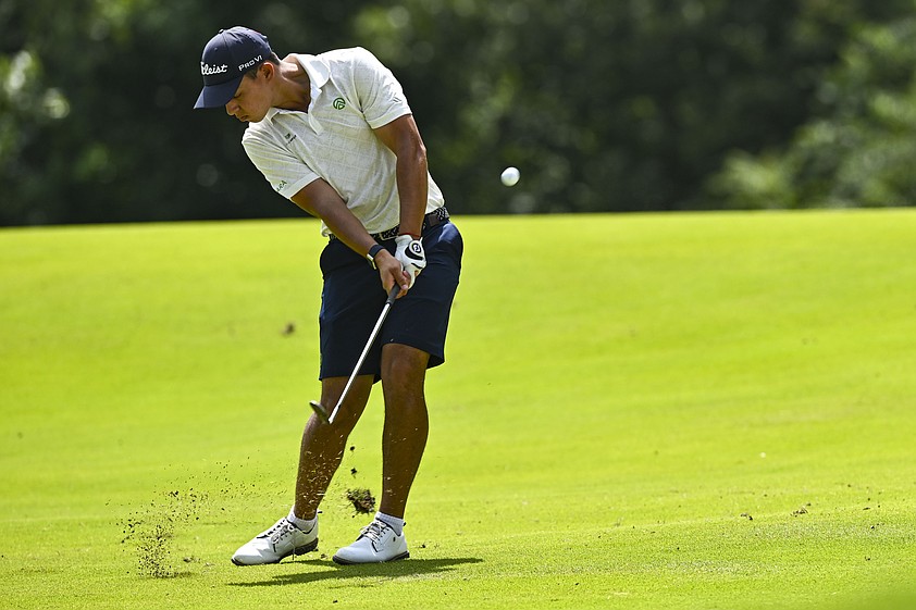 Erich Fortlage of Paraguay hits an approach shot on hole No. 11 ...