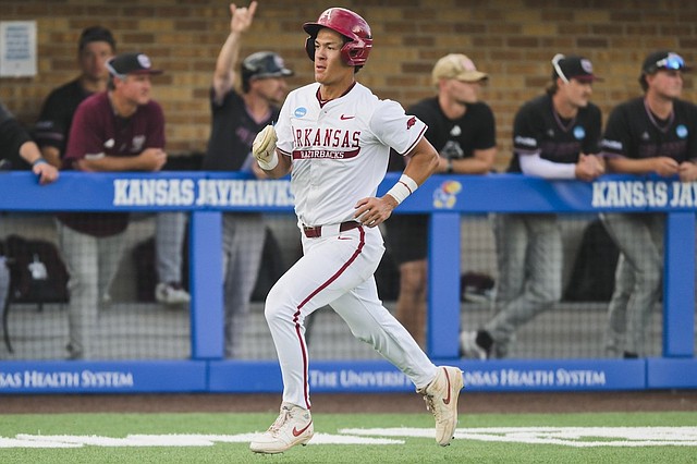 Arkansas second baseman Nolan Souza runs to home plate to score a run ...