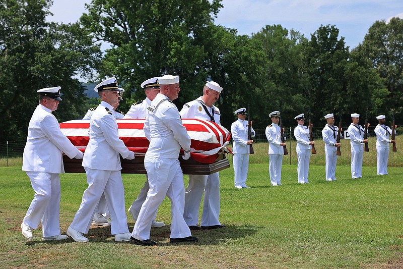 Military honor guard members carry the casket of Arkansas native Royle ...