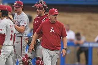 Arkansas head coach Dave Van Horn makes a pitching change, Saturday ...