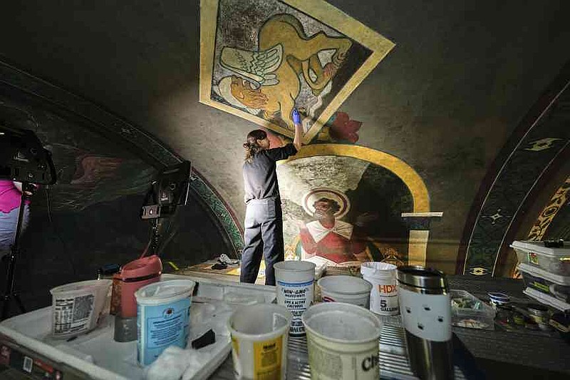 Inside a historic church painted with murals that reflect searing ...