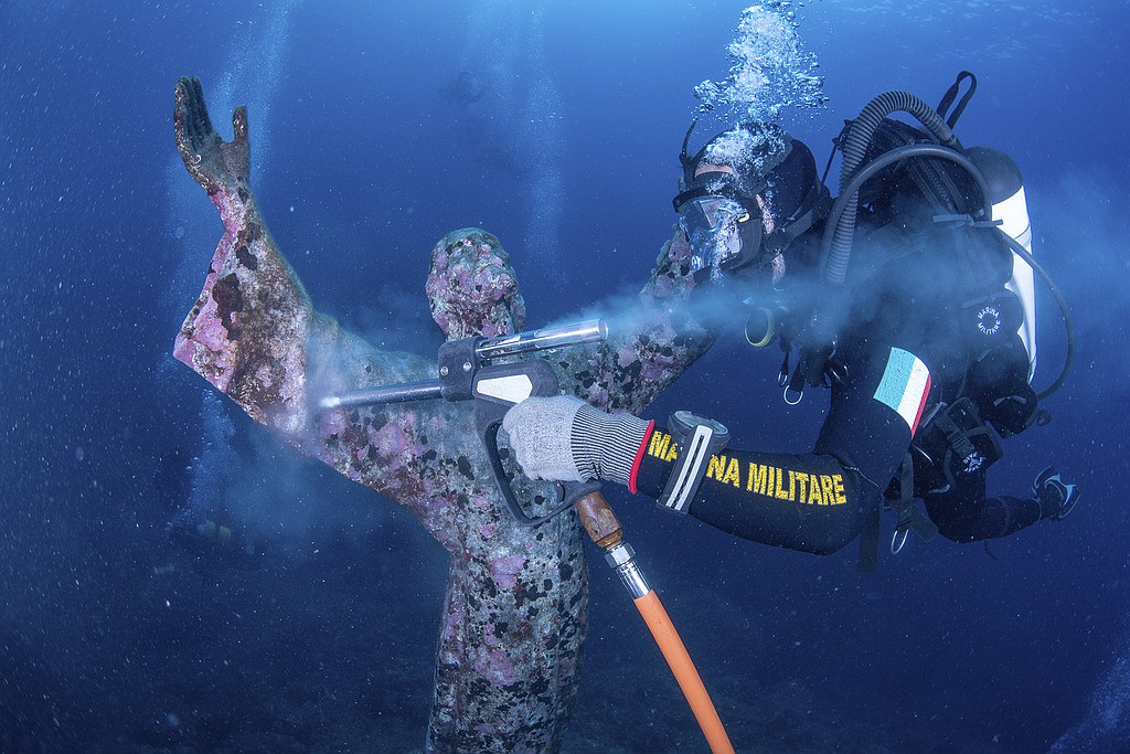 Divers water-blast the popular underwater statue of Christ off ...