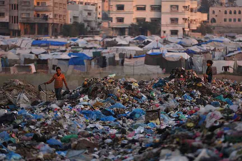 People in Gaza dig through garbage for things to burn to keep warm — a ...