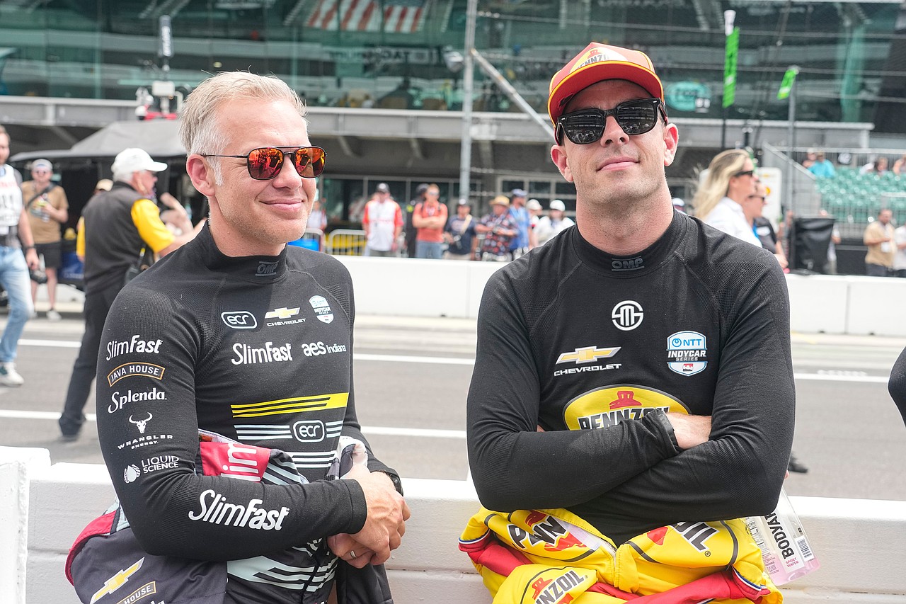 Ed Carpenter, left, talks with fellow IndyCar driver Scott McLaughlin ...