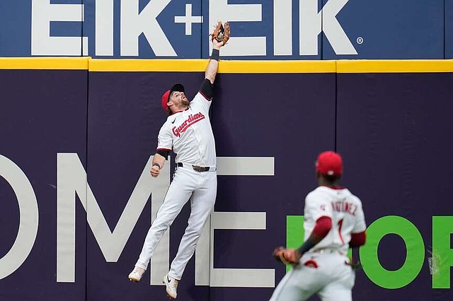 Cleveland Guardians center fielder Daniel Schneemann catches a fly ball ...