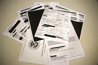 Staff photo by Jules Feeney / With significant redactions, documents ...