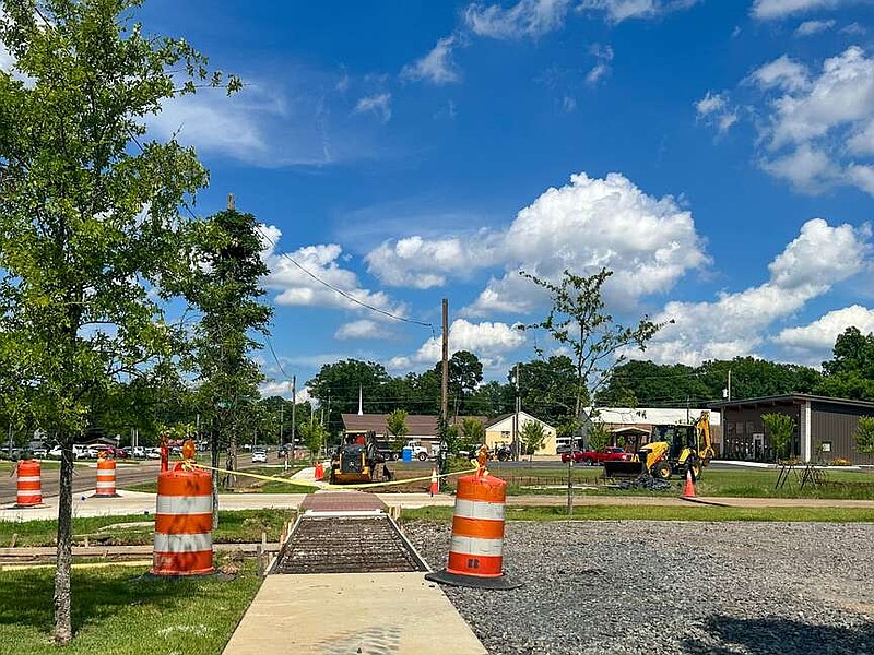 Construction workers continue adding sidewalks along East New Boston ...