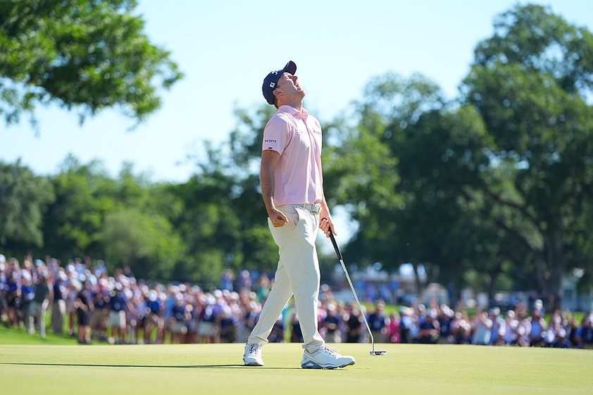 Russell Henley reacts after sinking a putt on the 18th hole at Colonial ...