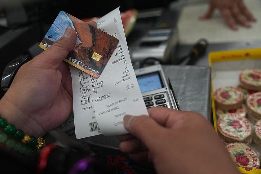 Jannette Victor checks her remaining balance after purchasing food ...