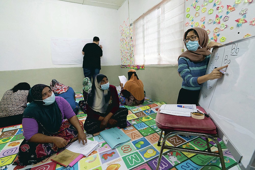 Malaysia group teaches refugee women how to read, write