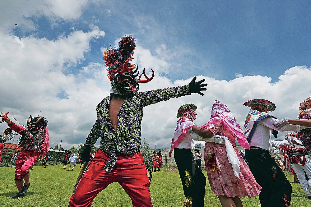 Devils dance, observe virus protocols at Ecuador festival
