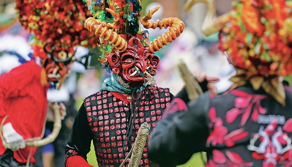 Devils dance, observe virus protocols at Ecuador festival