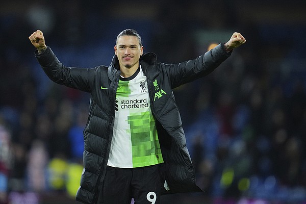 Liverpool moves to the top of the Premier League. Woods scores hat ...