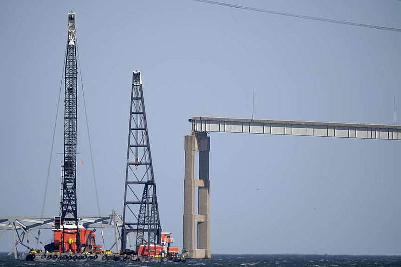 As heavy-duty cranes arrive at Baltimore bridge collapse site, governor ...