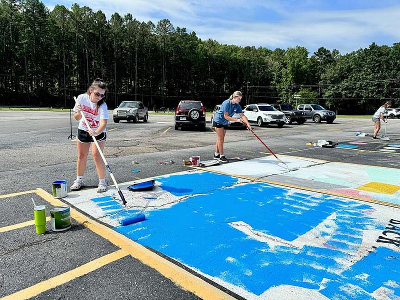 WATCH | Mountain Pine Red Devil cheerleaders fundraise by painting ...