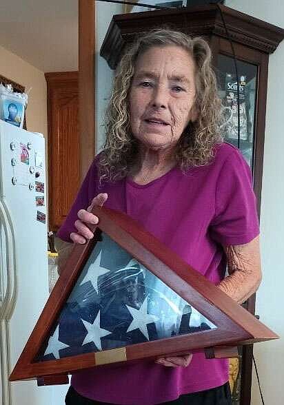 Daughter of late veteran receives service flag from post commander ...