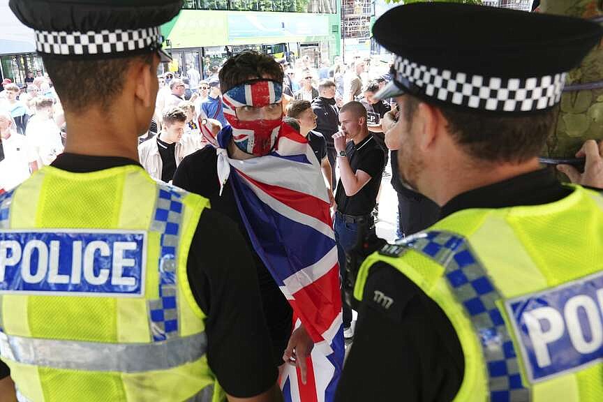 British police officers injured in clash with far-right activists ...