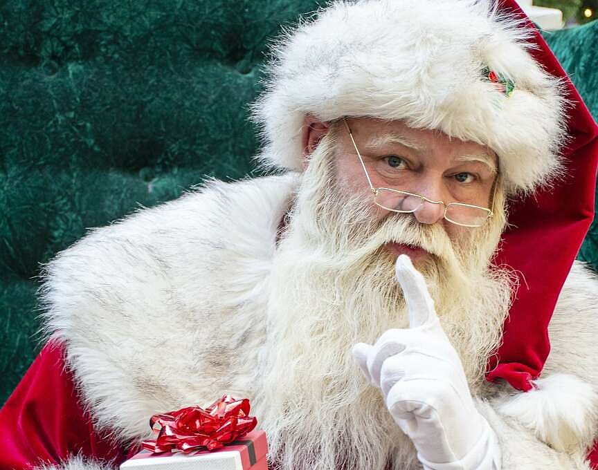 MERRY CHRISTMAS: Busy as he is, the jolly ol’ elf takes time out for an ...