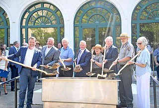 Officials take part in a ceremonial groundbreaking in front of the ...