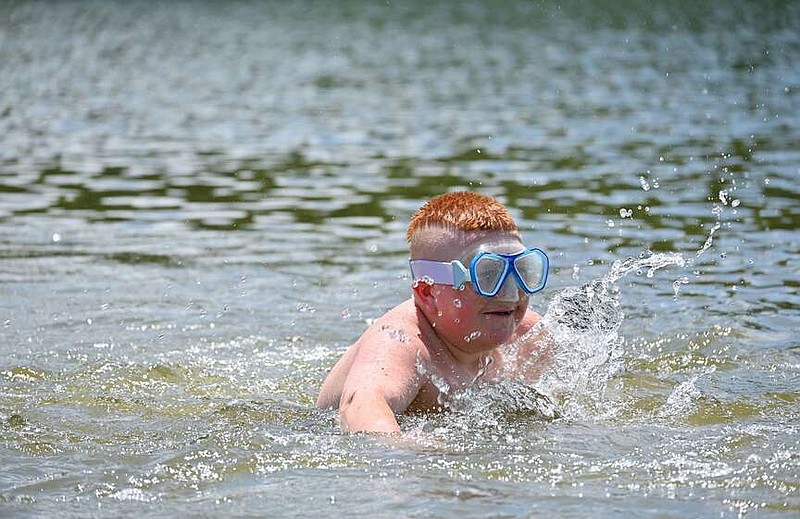 Gabriel Sexton, 12, of Rogers swims on Saturday as part of the free ...