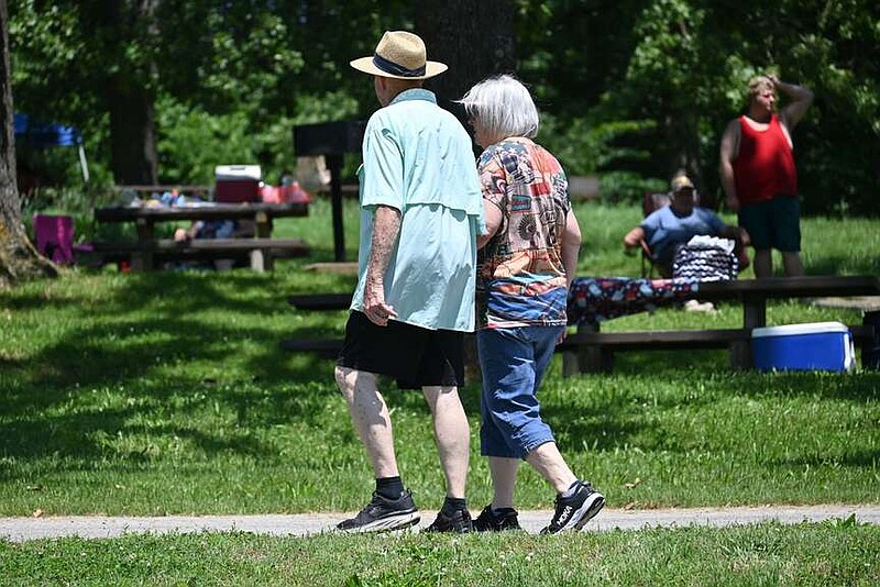 A couple strolls along a path on Saturday during the free, one-day ...