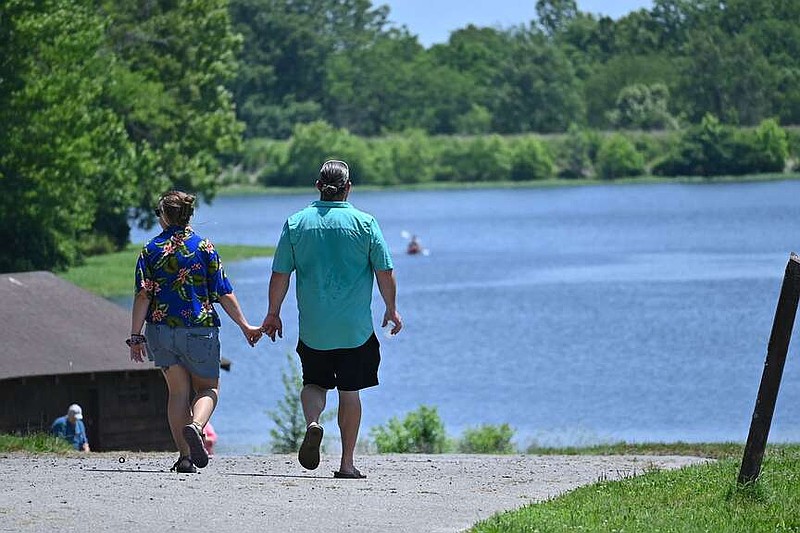 A couple walks toward the water on Saturday during the free, one-day ...