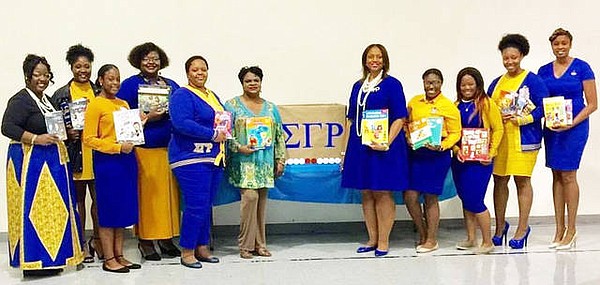 Sigma Gamma Rho presents book donation at event