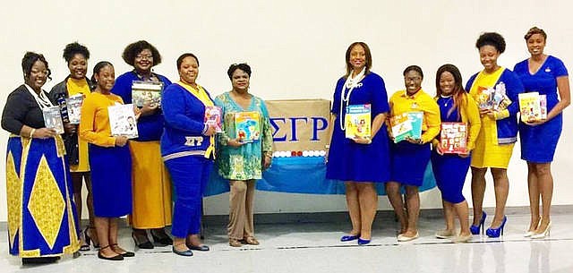 Sigma Gamma Rho presents book donation at event