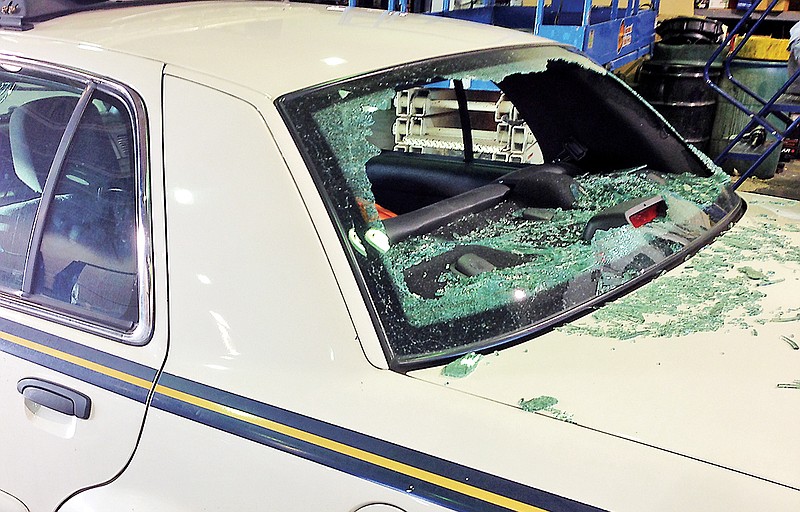 Man arrested after breaking police car's windshield, spitting on ...