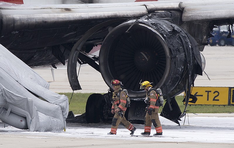 Plane catches fire at airport; passengers evacuate on slides ...