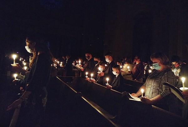Singing hymns through masks, Christians mark pandemic Easter ...